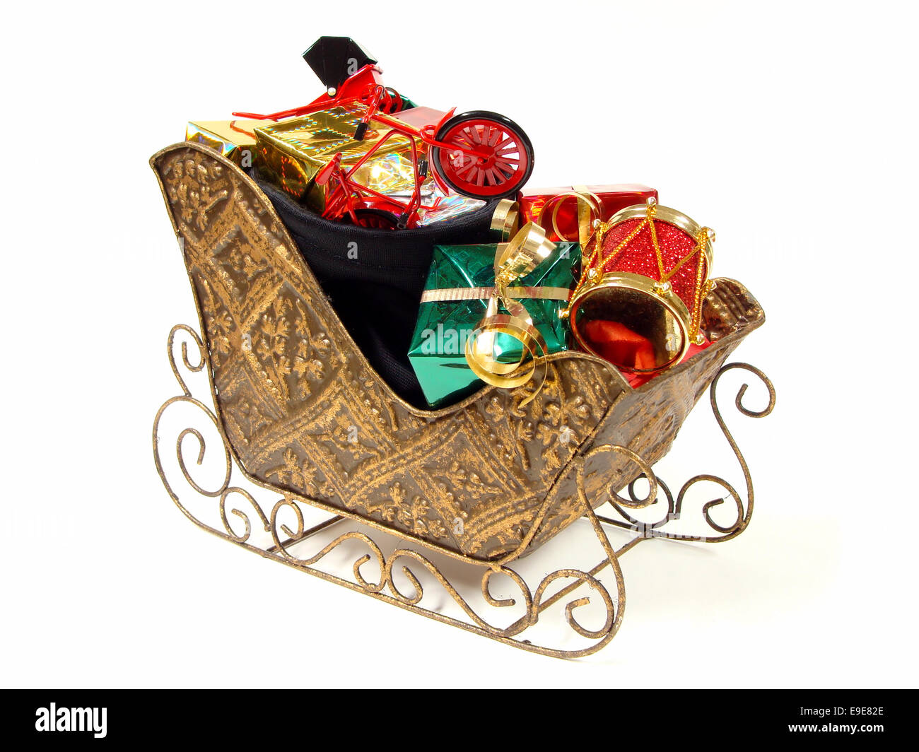 Christmas sleigh filled with a bag of gifts and toys over a white ...