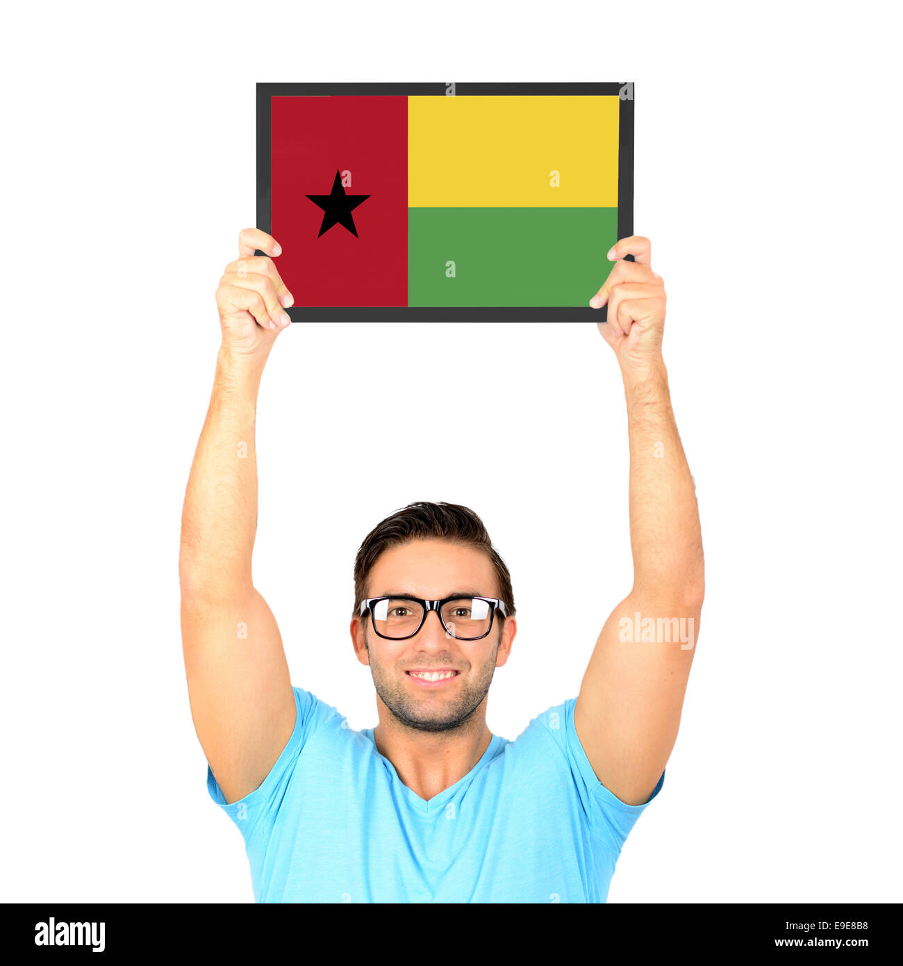 Portrait of a young casual man holding up board with National flag of ...