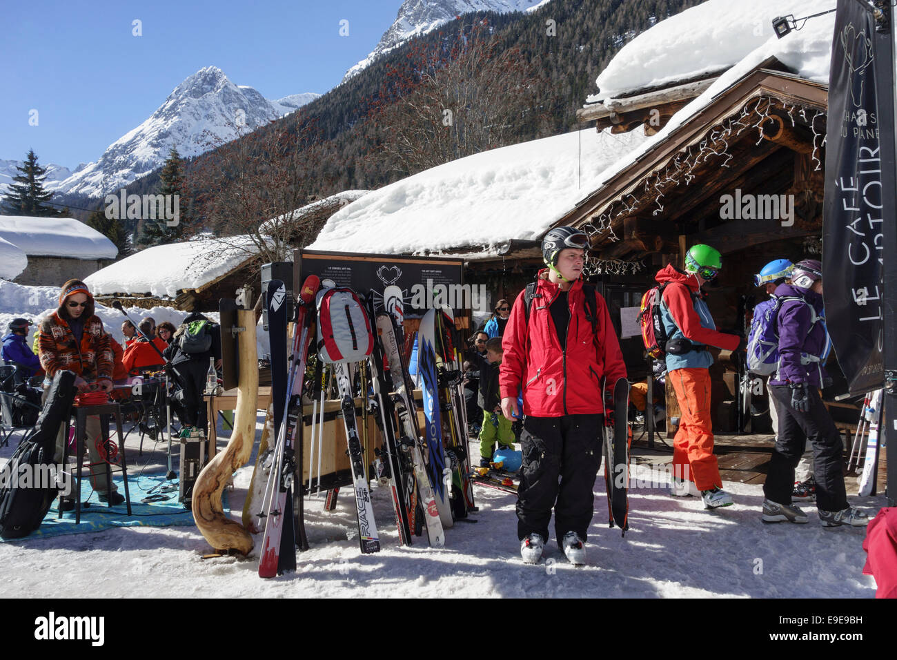 Skiers and skis outside traditional Alpine ski restaurant Le Café ...