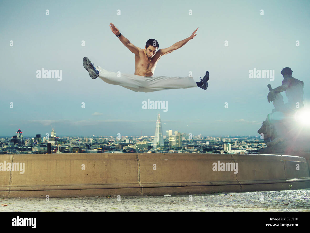 Strong muscular man doing the splits Stock Photo - Alamy