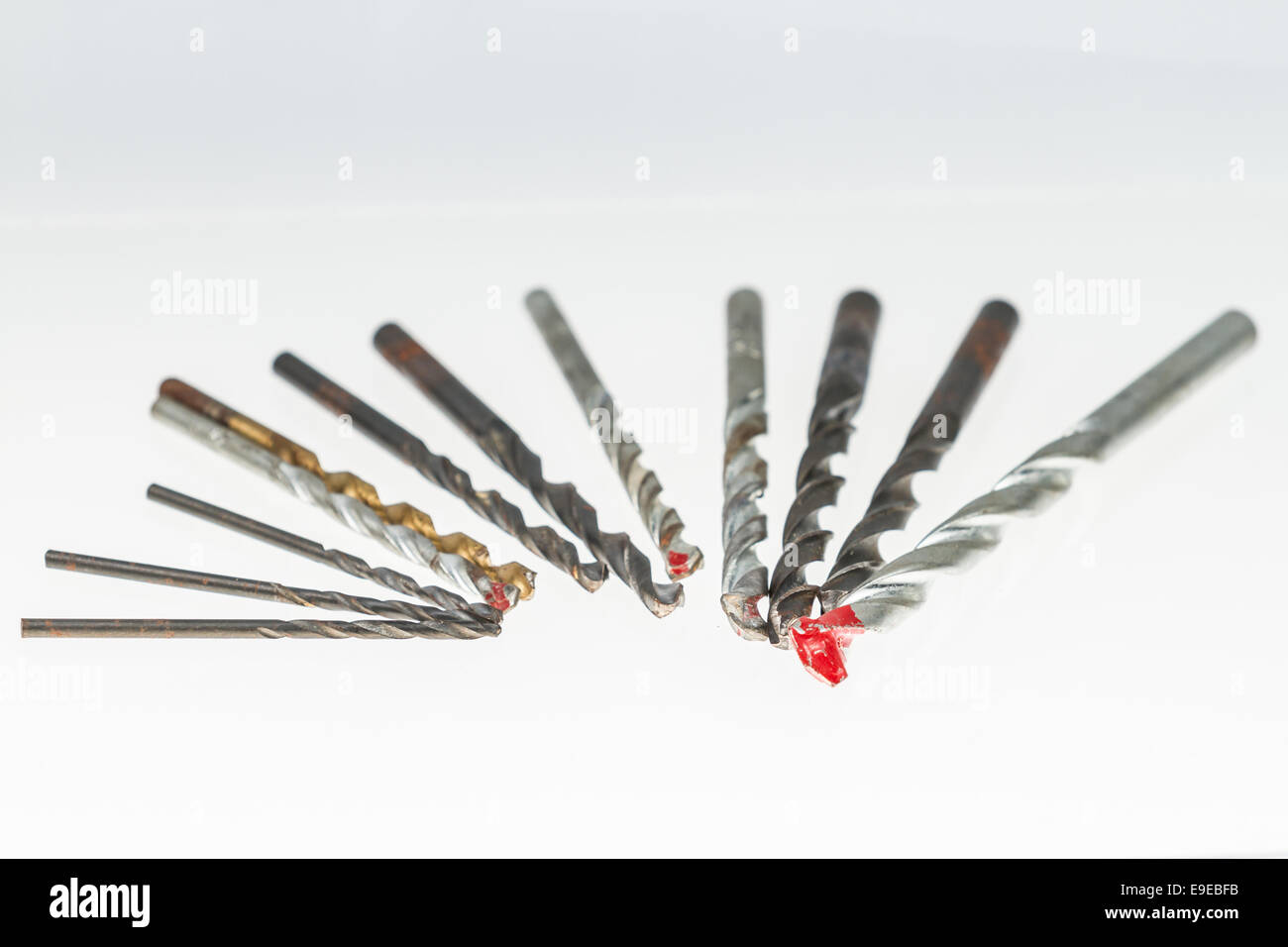 Assorted drill bits on isolated white background Stock Photo - Alamy