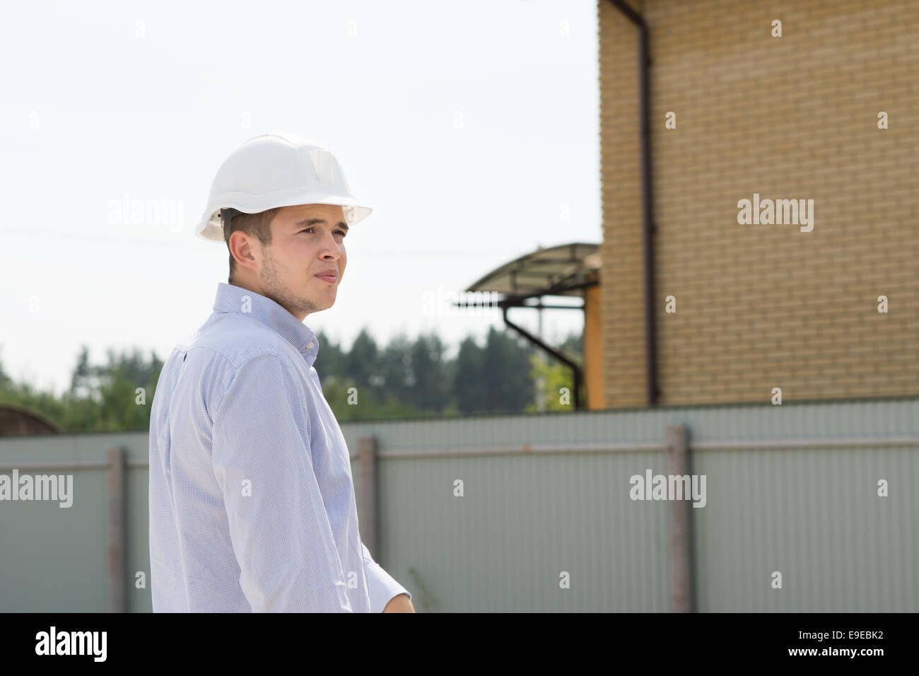 Young Male Civil Engineer Wearing White Helmet Visits Site to See ...