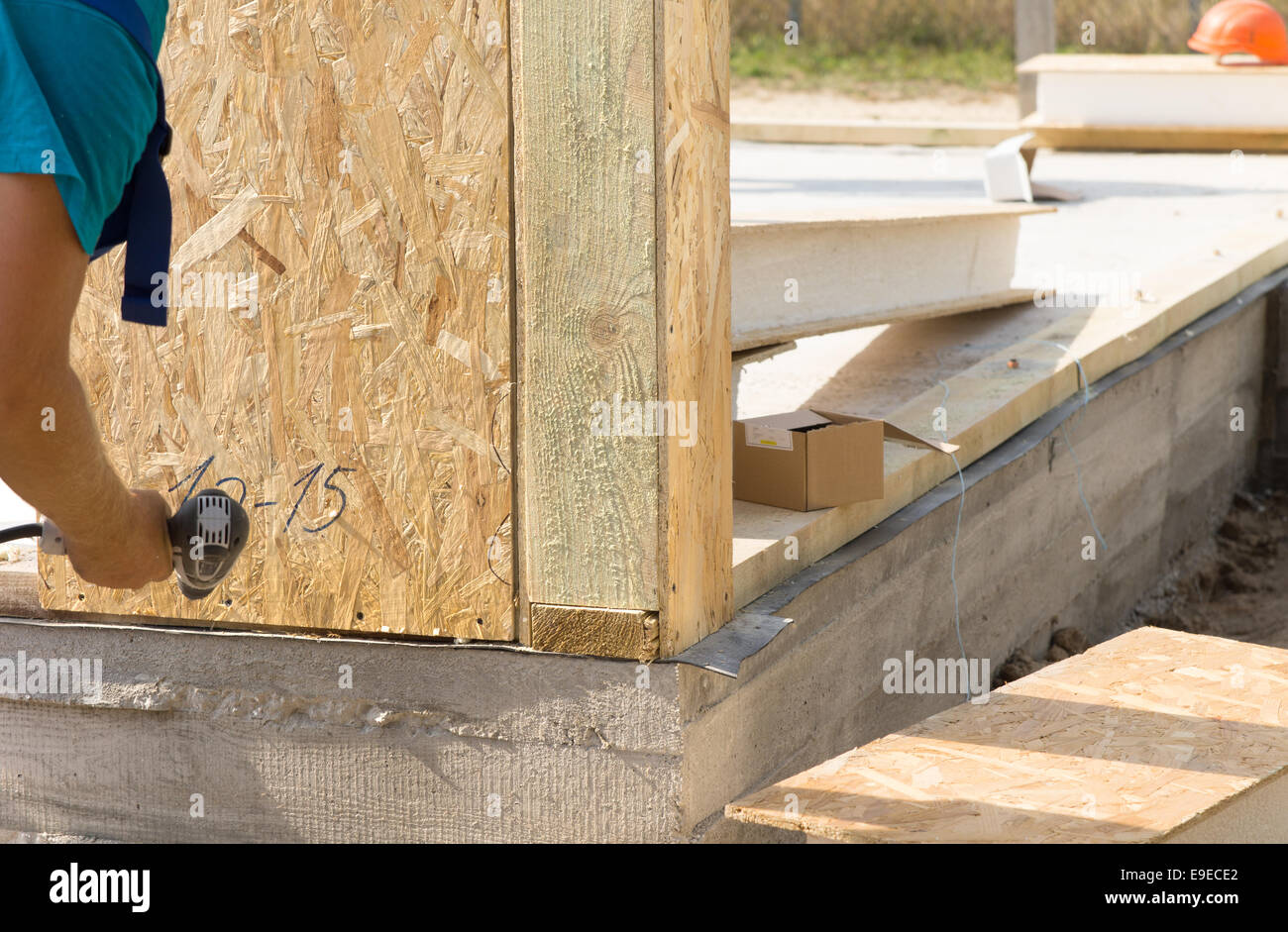 Construction worker installing wall insulation on a new build house ...