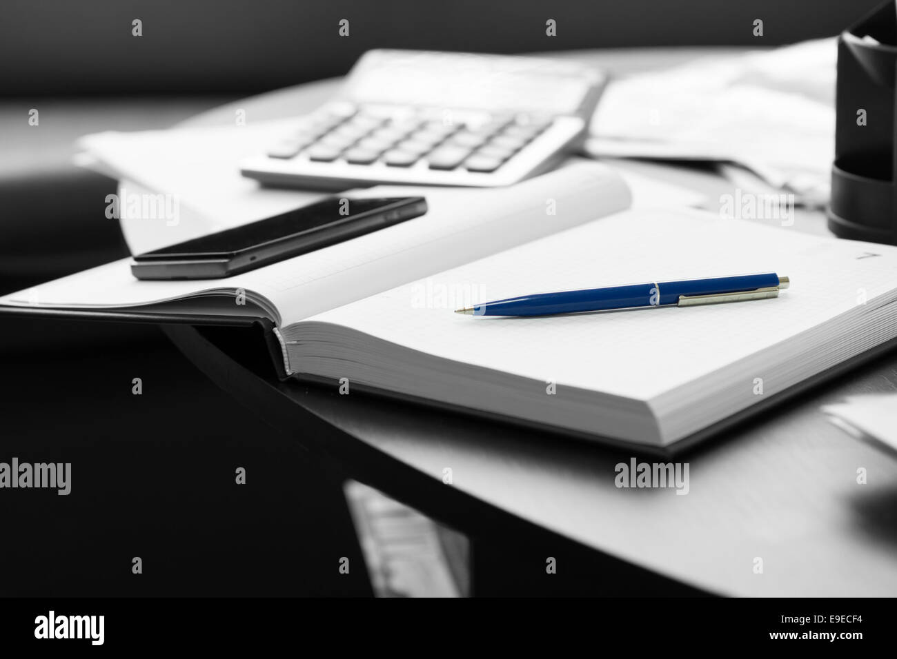 Close up White Memo Notebook with Blue Pen and Mobile Phone on Black ...