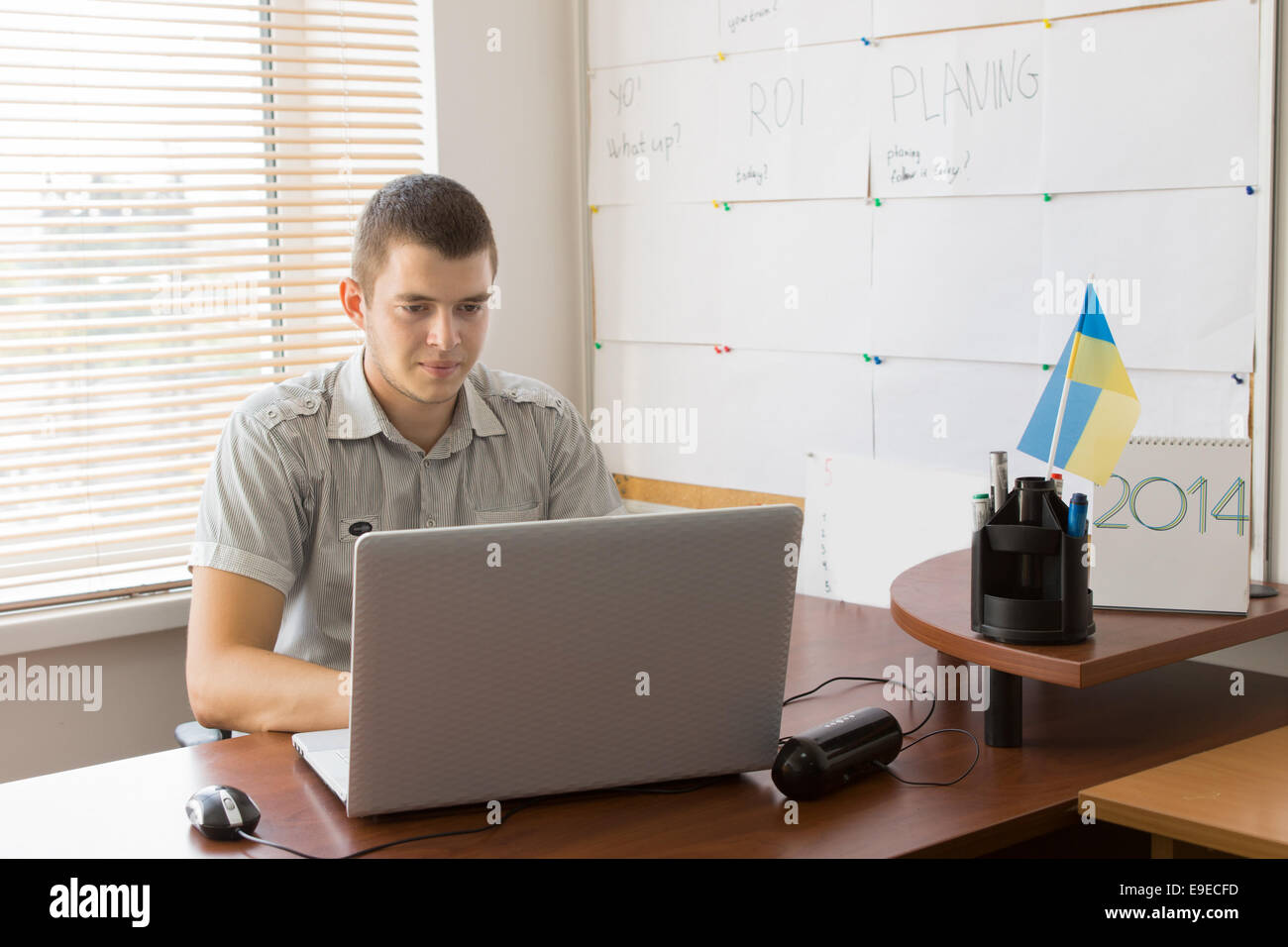 Young White Male Office Worker Busy Working with His Laptop Computer at ...