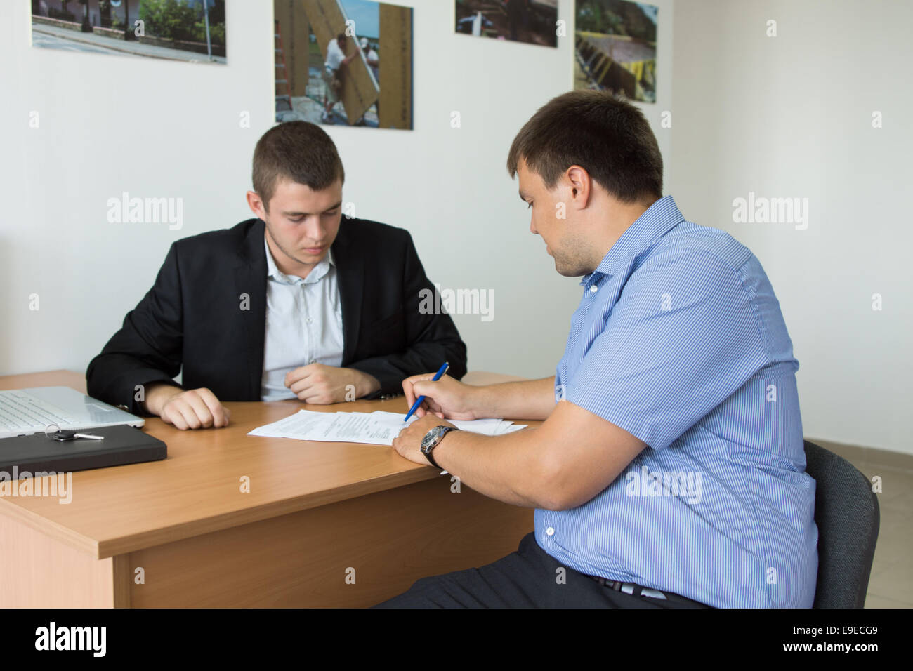 Male client signing agreement on hi-res stock photography and images ...