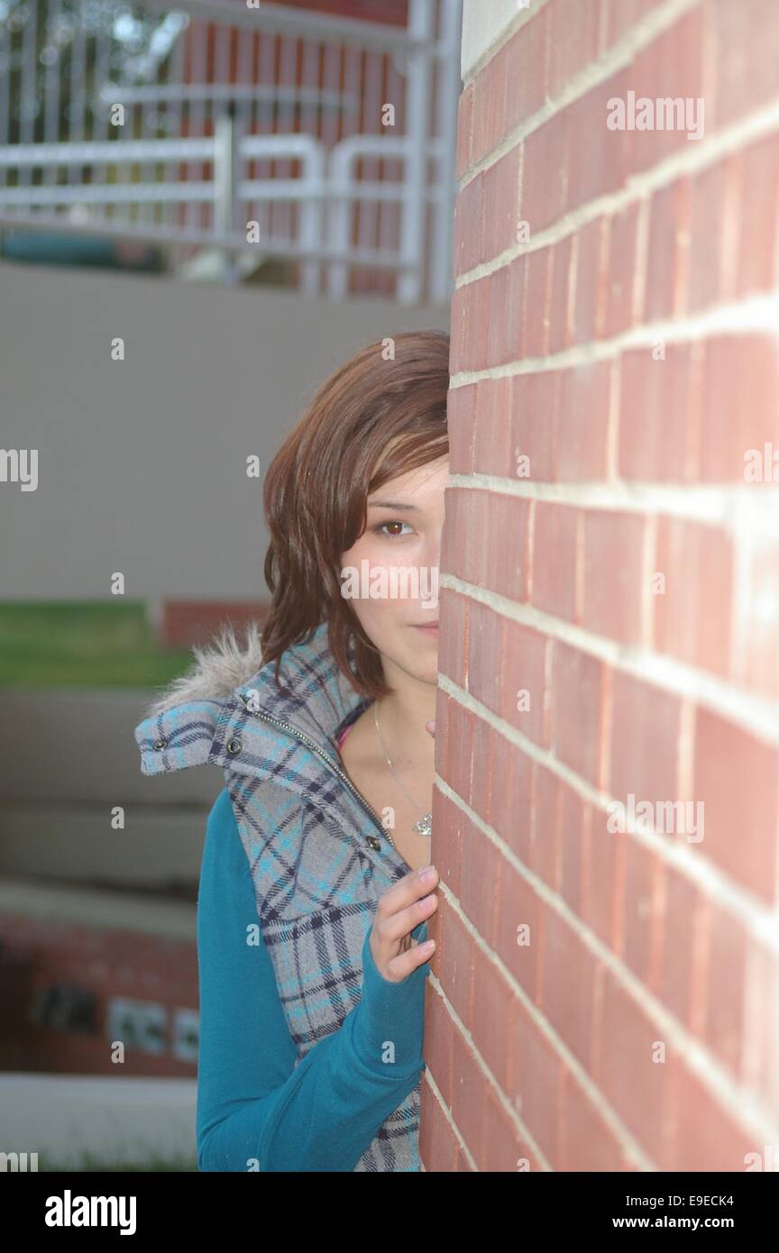 Girl hiding building hi-res stock photography and images - Alamy