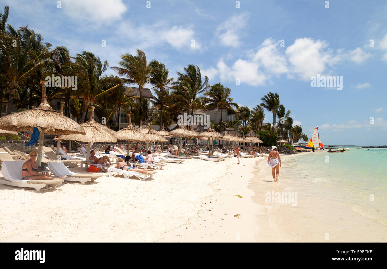 Mauritius beach - People sunbathing with parasols, Belle Mare beach ...