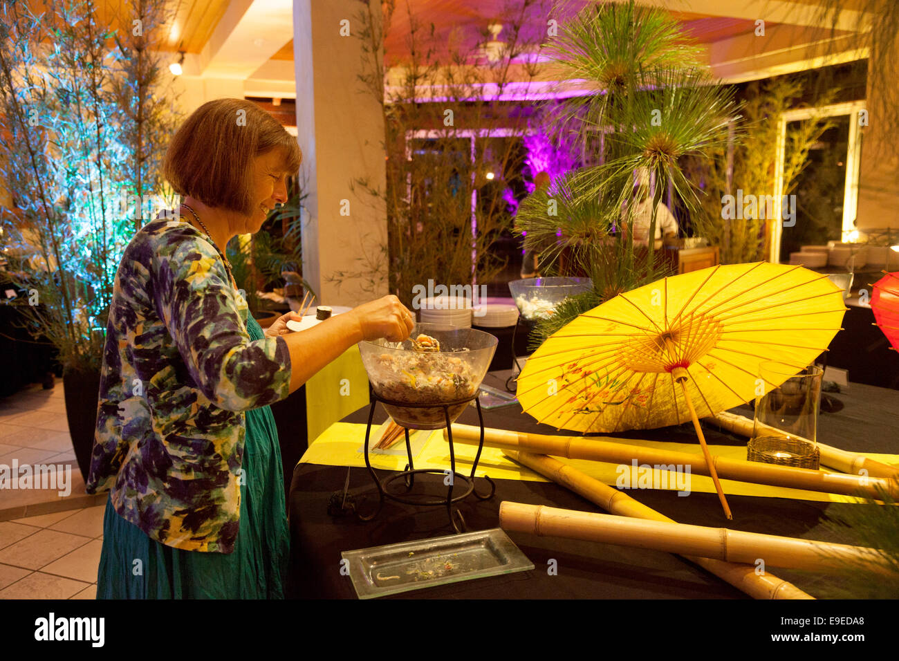 A woman tourist choosing food from the dinner buffet, the luxury 5 star ...