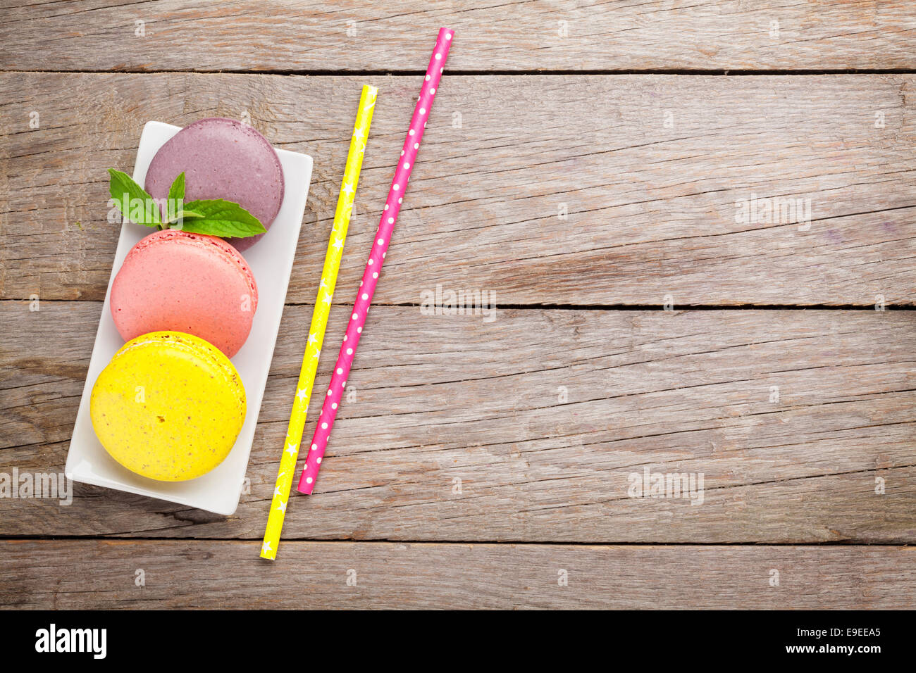 Colorful macaroon cookies on wooden table background with copy space ...
