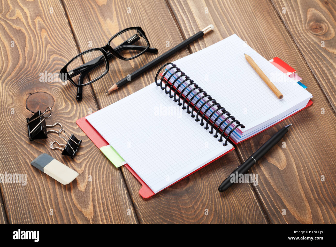 Office table with notepad, colorful pencils and supplies. View from ...