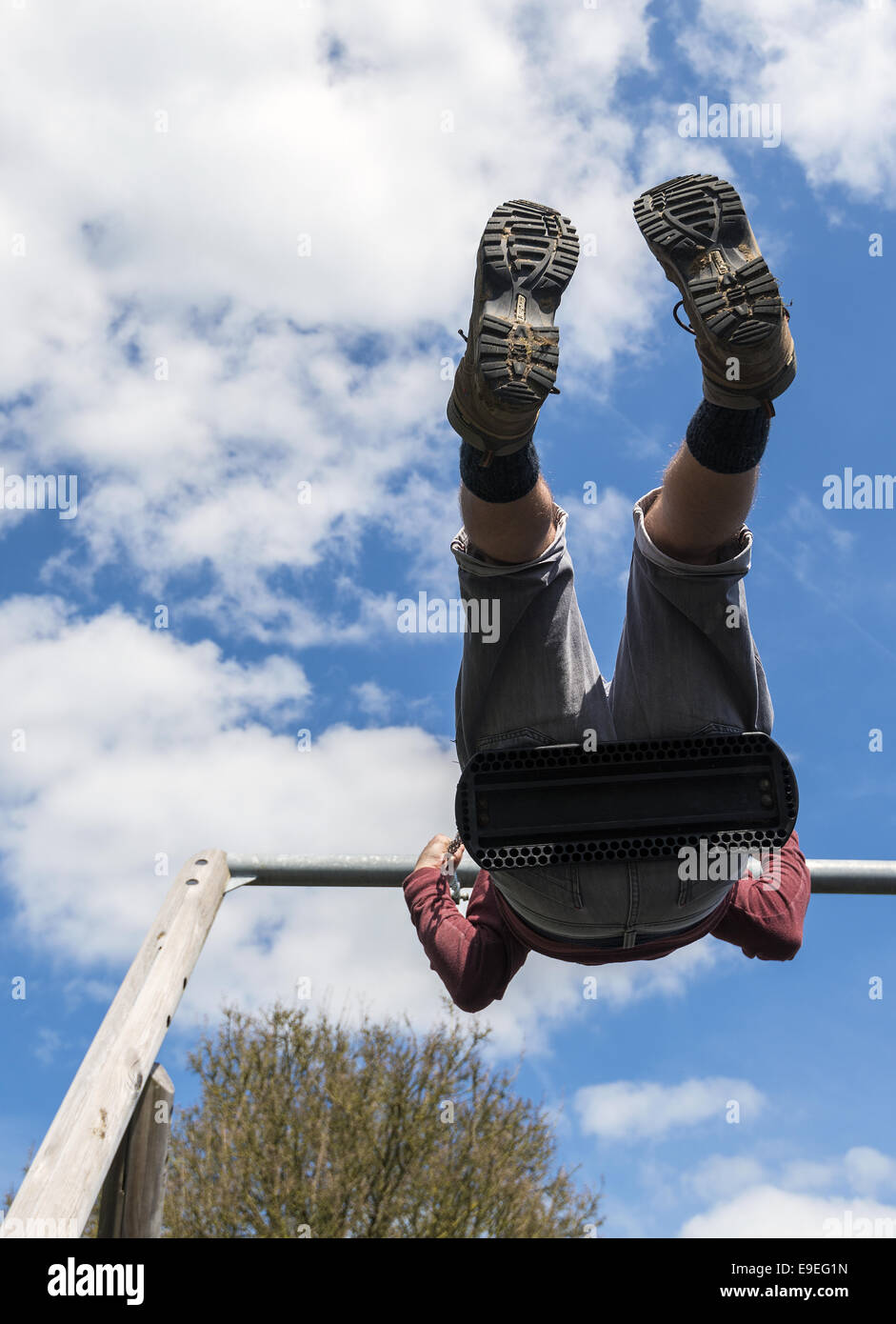Teenager on swing underneath viewpoint Stock Photo - Alamy