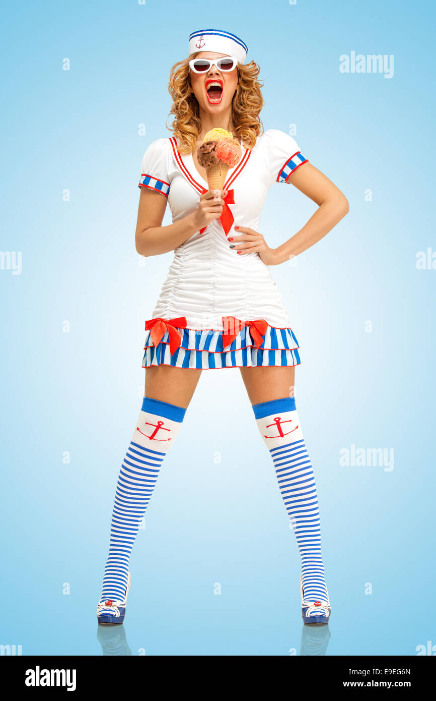 Creative retro photo of a fashionable pin-up sailor girl, holding an ...