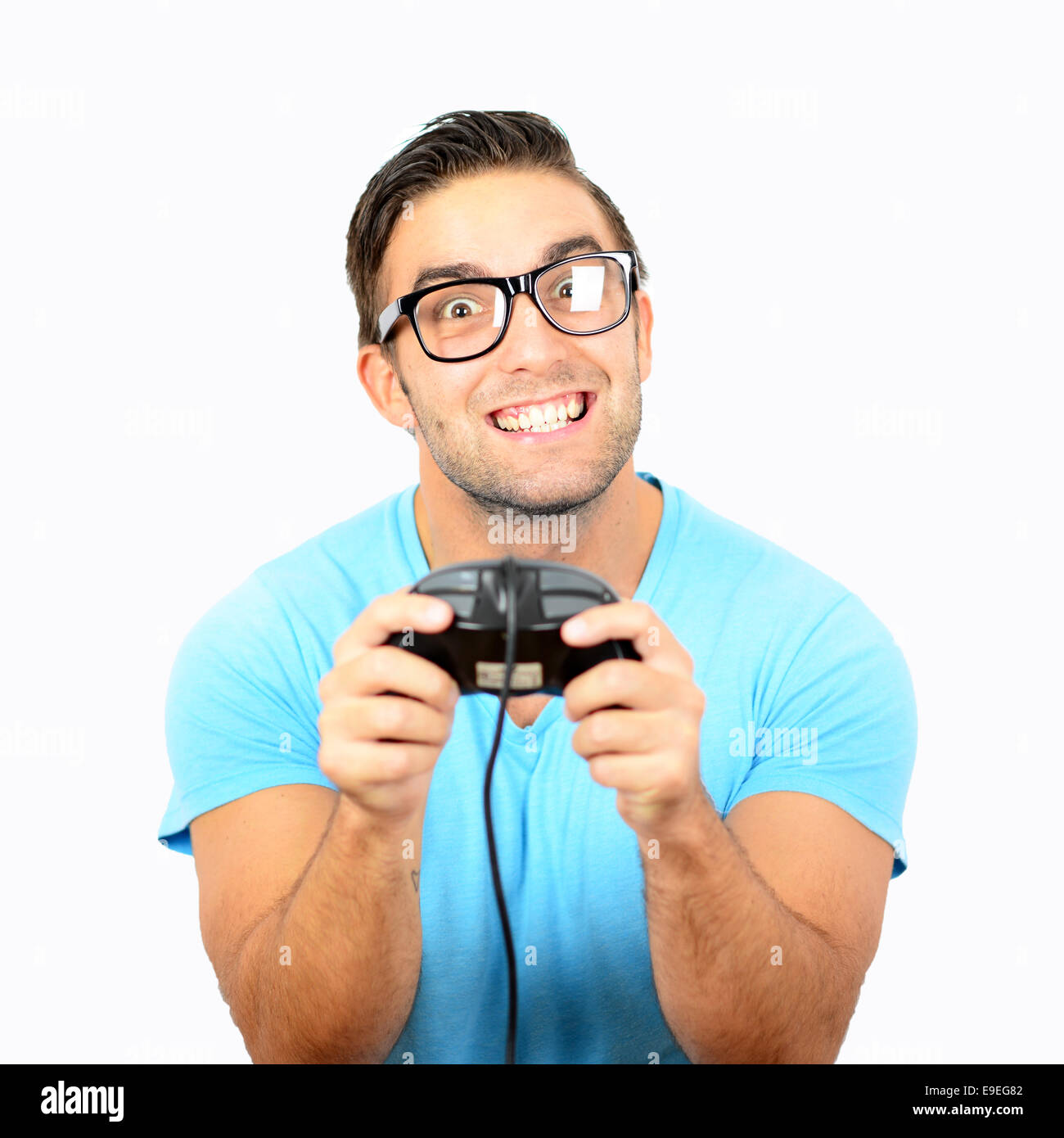 Portrait of handsome man holding joystick for video games against white ...
