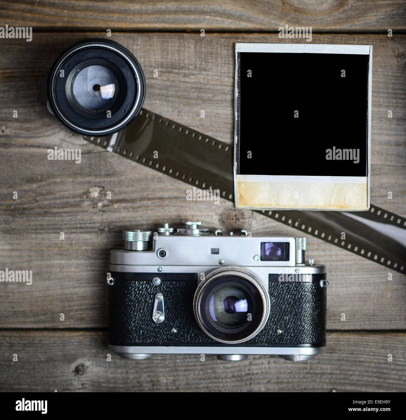 Vintage camera with lenses and blank old photograph on wooden ...