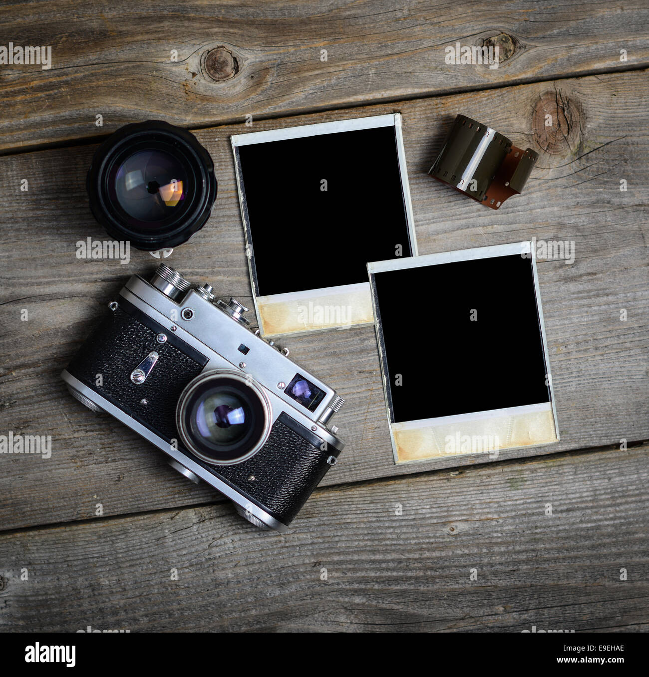 Vintage camera with lenses and blank old photograph on wooden ...