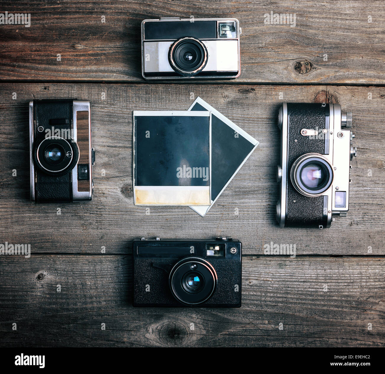 Vintage cameras around empty retro photograph on wooden background ...