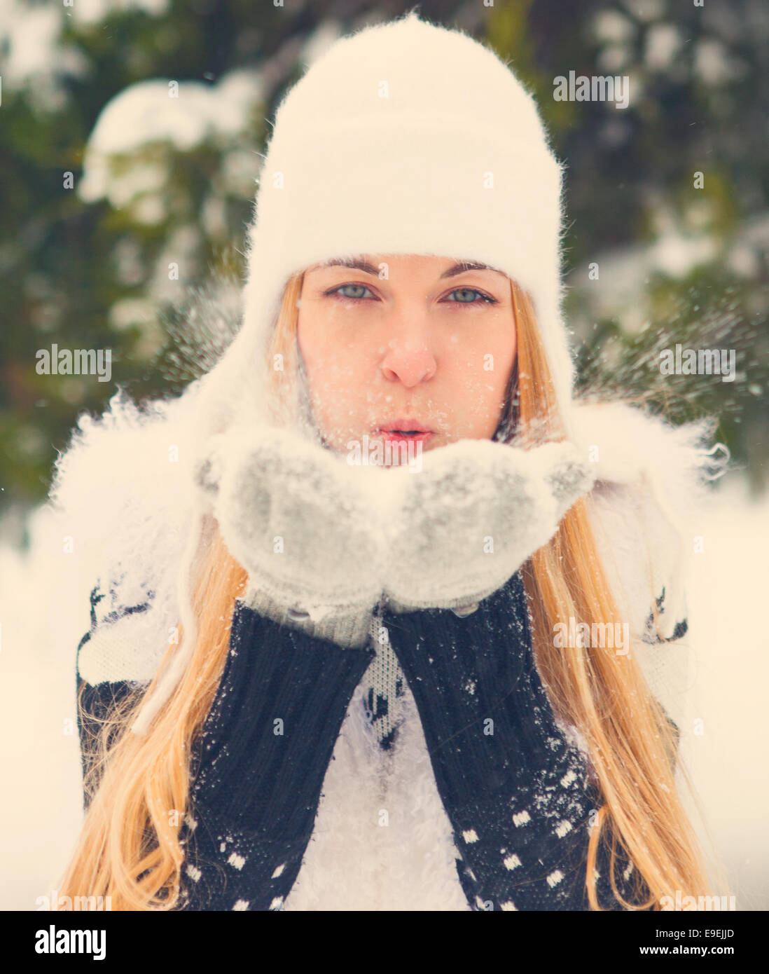 Beautiful blond woman blowing snow outdoors Stock Photo - Alamy