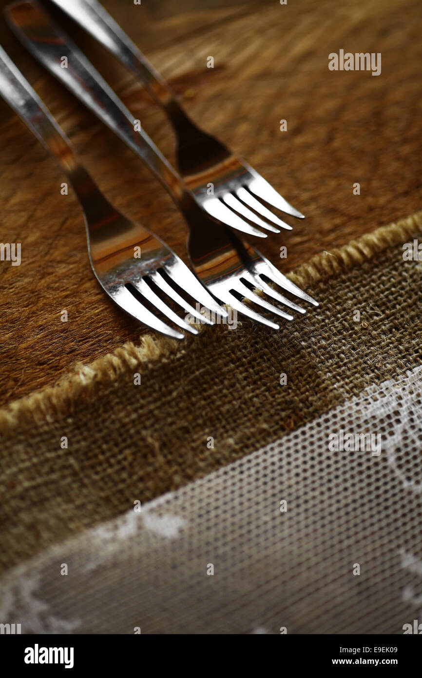 Shot with some forks on a table in a restaurant Stock Photo - Alamy