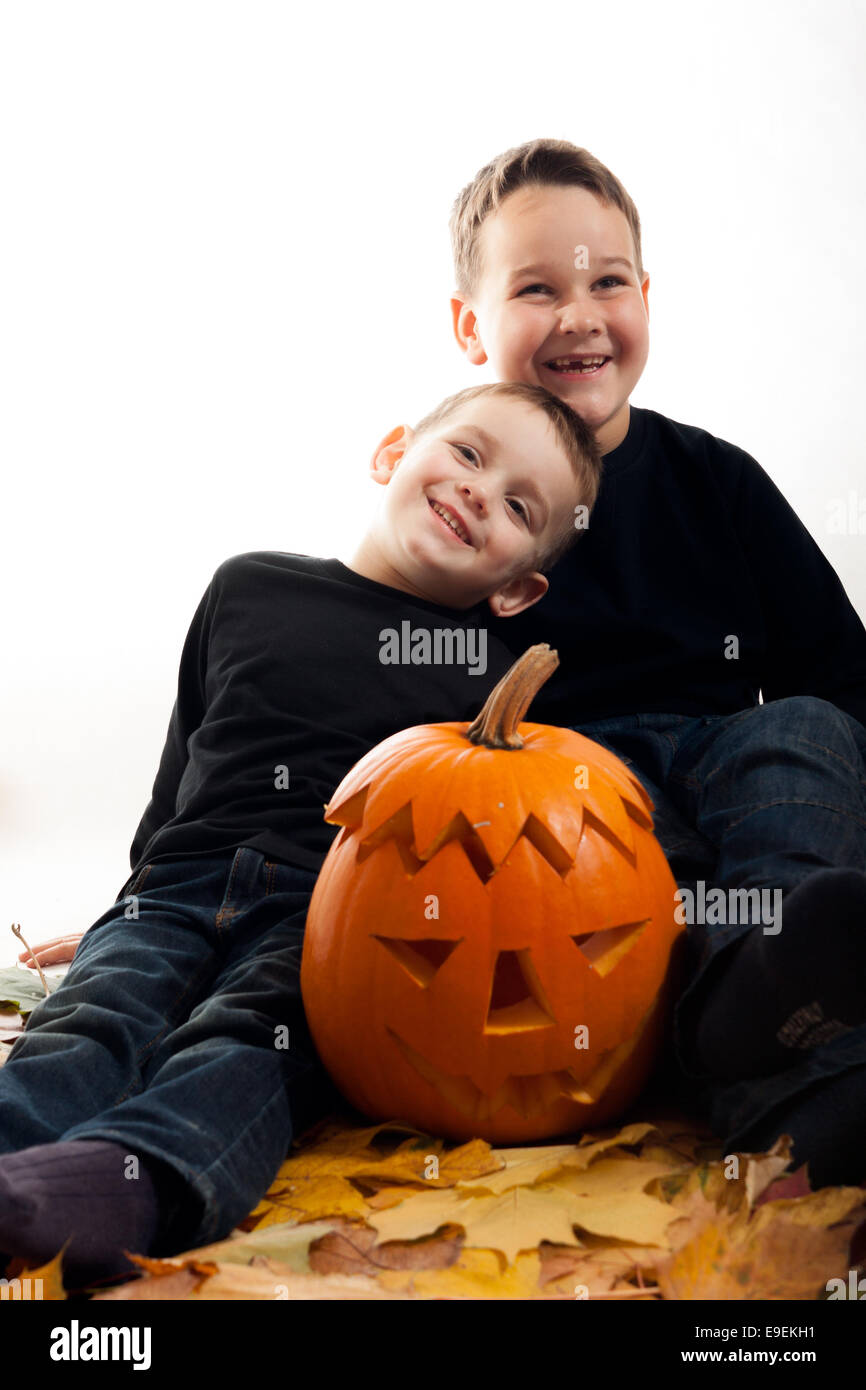 A cute photograph of a two boys and her Halloween pumpkin Stock Photo ...