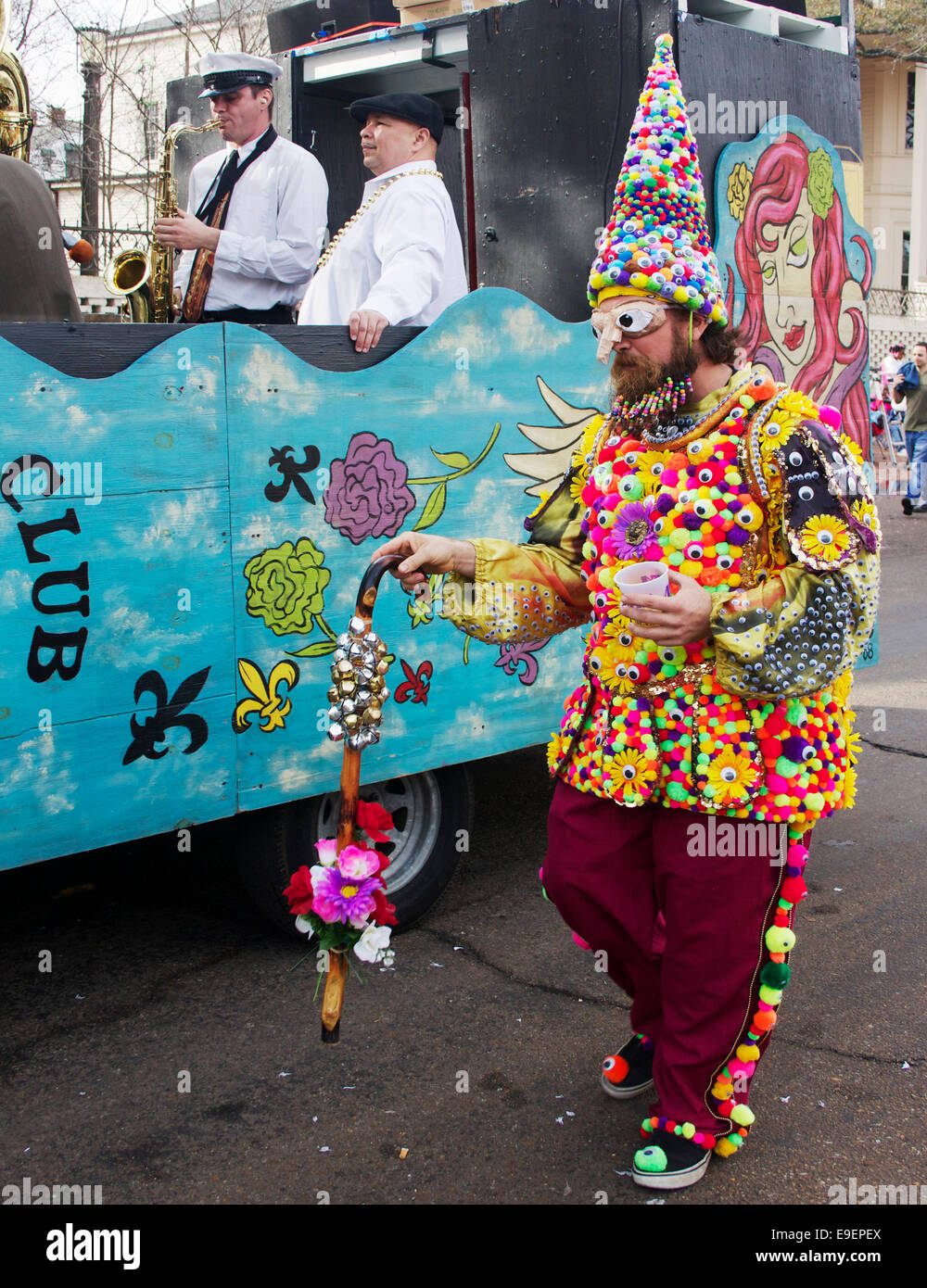 Cajun-costumed man walking alongside a float on Mardi Gras day, New ...