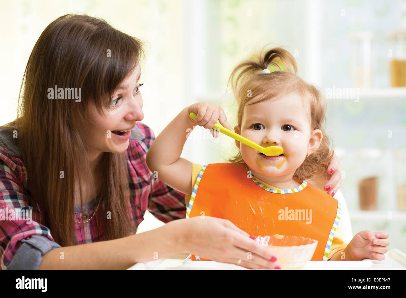 kid girl eating with spoon indoors Stock Photo - Alamy