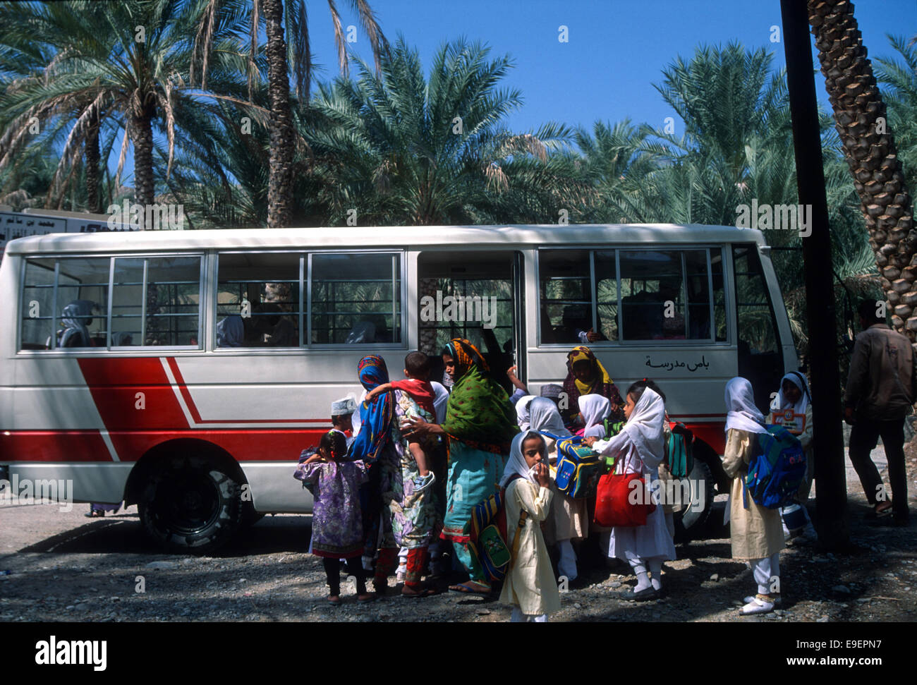 Rural children catching the school bus in the interior of Oman Stock ...