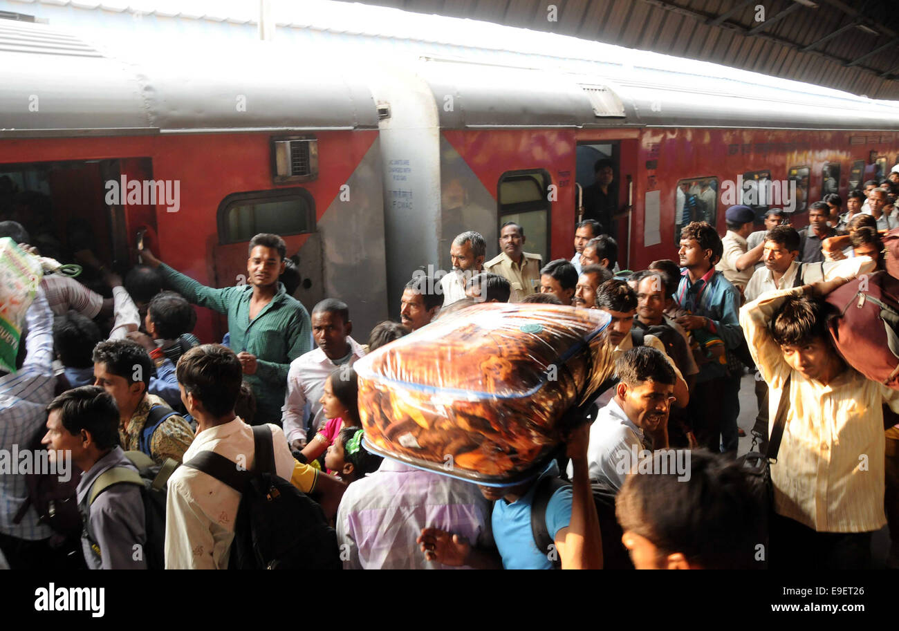New Delhi, India. 26th Oct, 2014. Passengers try to board the Bihar ...