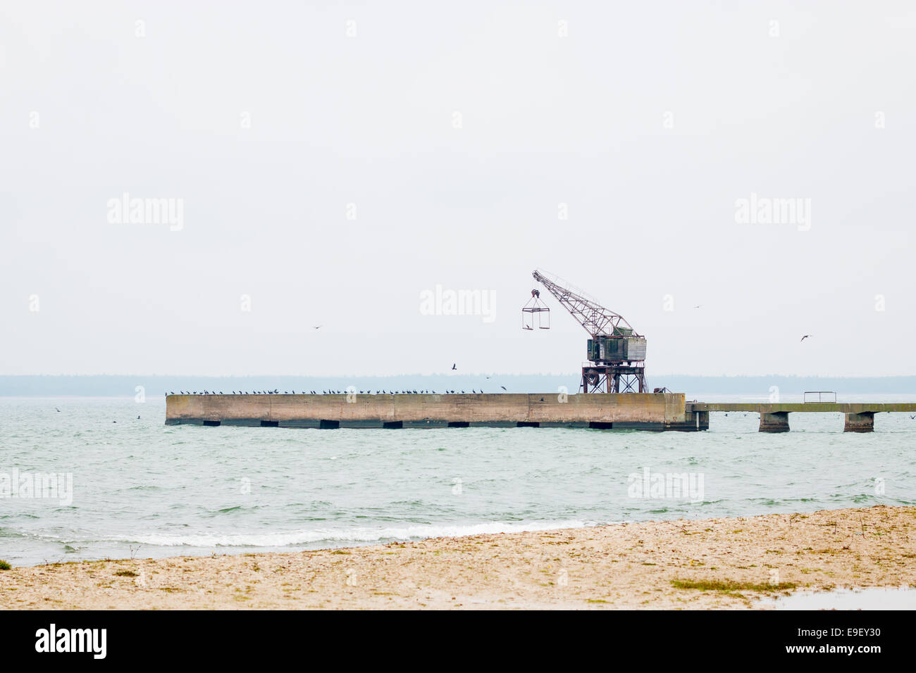 Shoreline with pier and crane during rough autumn weather in Gotland ...