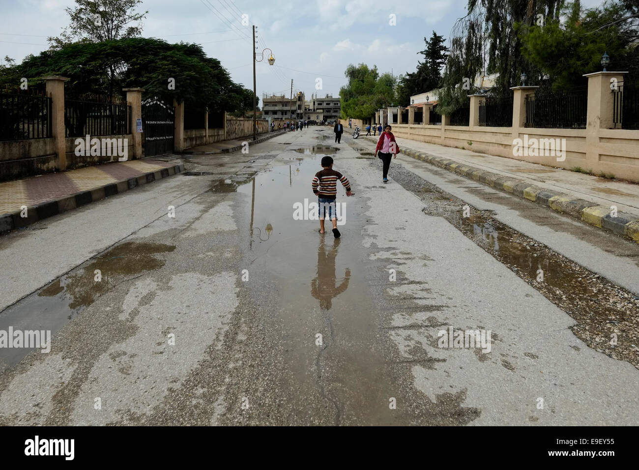 Children walking in the city of Al-Malikiyah also called Derek ...