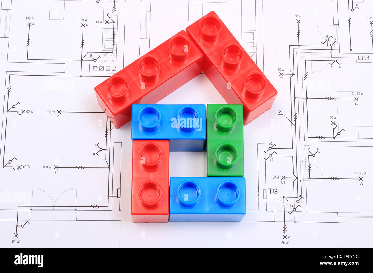 House shape of colorful plastic building blocks lying on construction ...