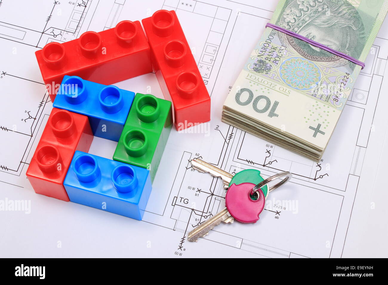House shape of colorful building blocks, home keys and banknotes lying ...