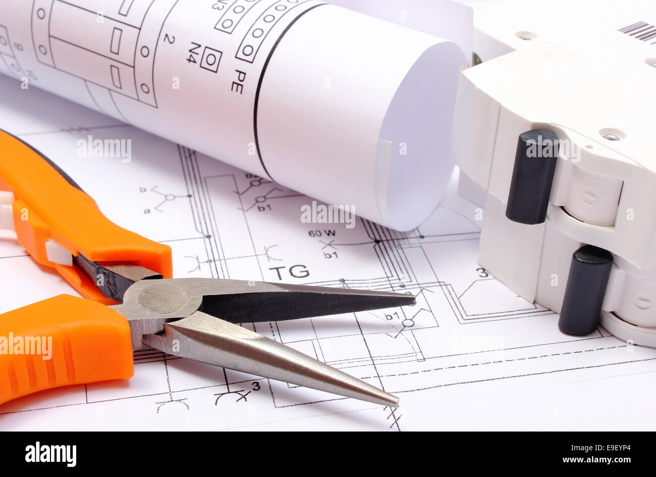 Rolled electrical diagrams, electric fuse and work tools lying on ...