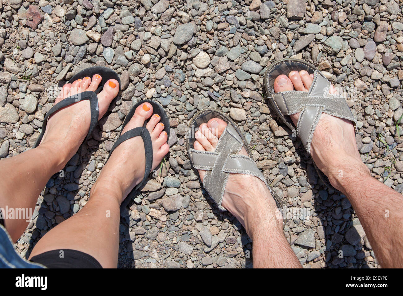 Adult couple with slippers standing on a stone beach Stock Photo - Alamy
