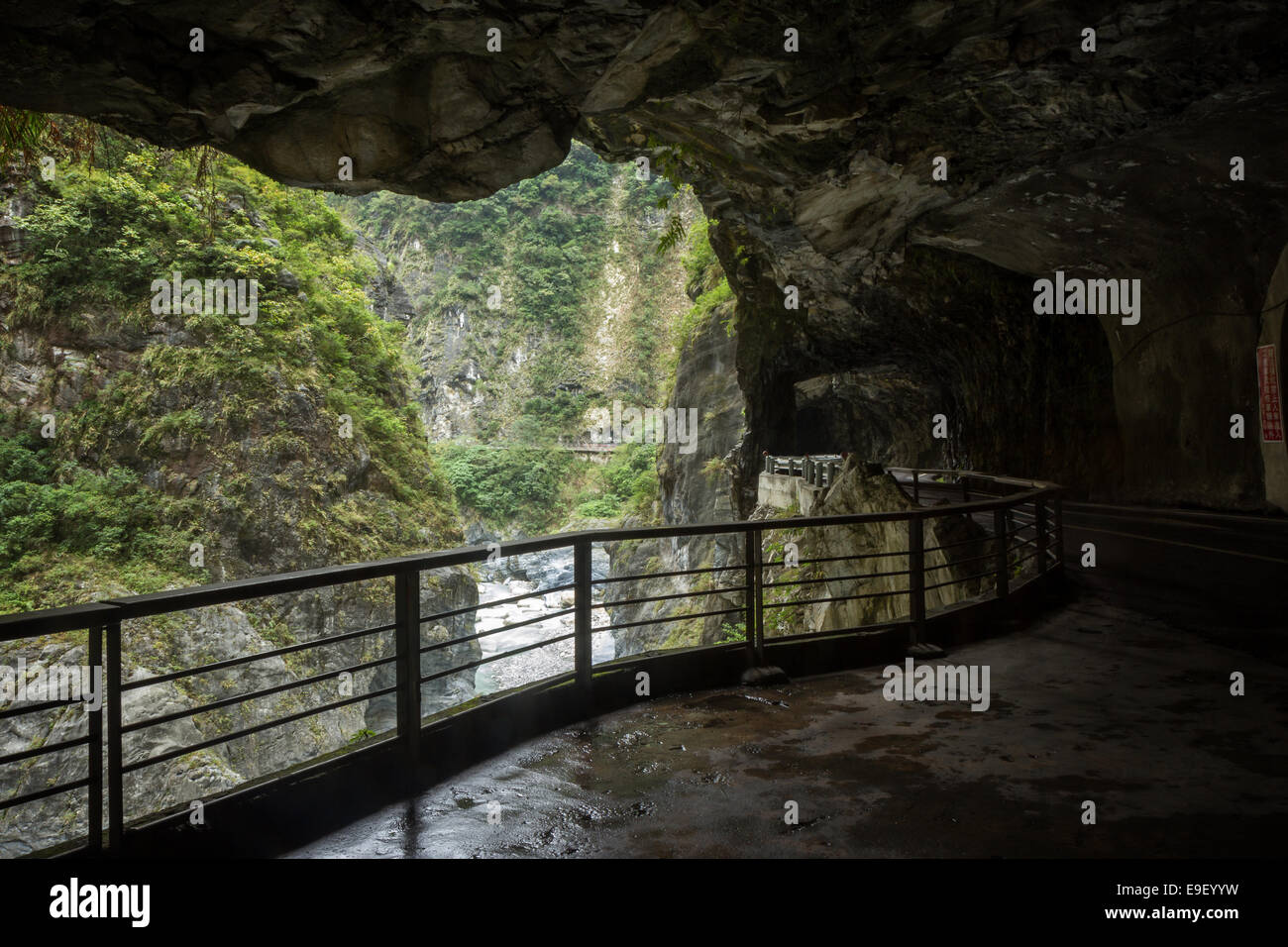 Steep rocks, deep gorge, footpath and small road dug into rock at ...