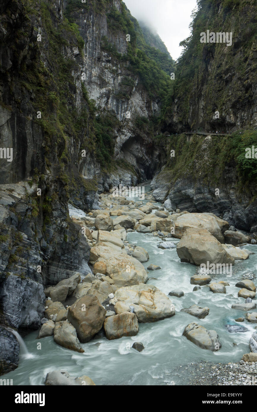 Steep cliffs, deep gorge and rocky river at Swallow Grotto (Yanzikou ...