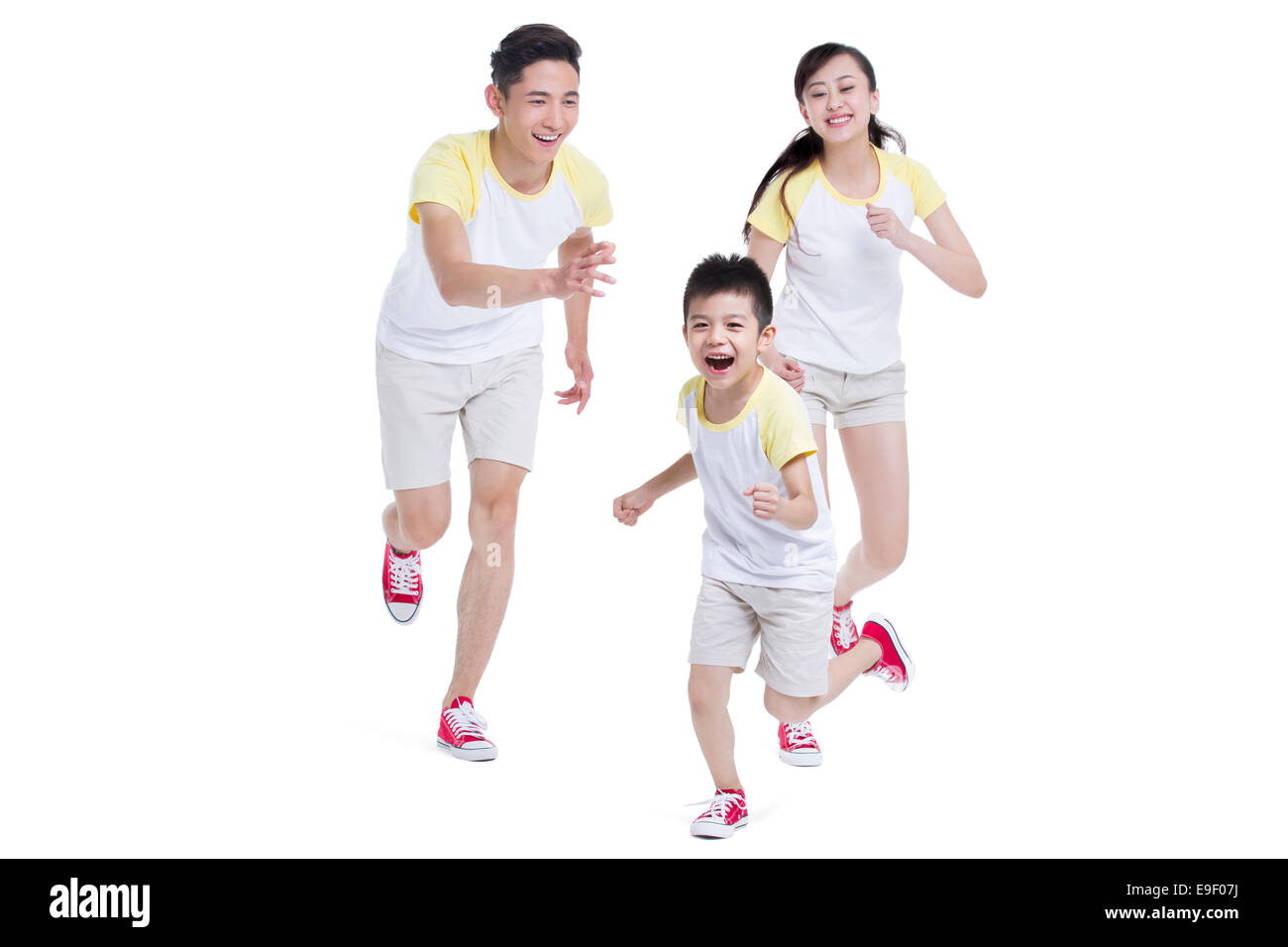 Happy young family chasing Stock Photo - Alamy