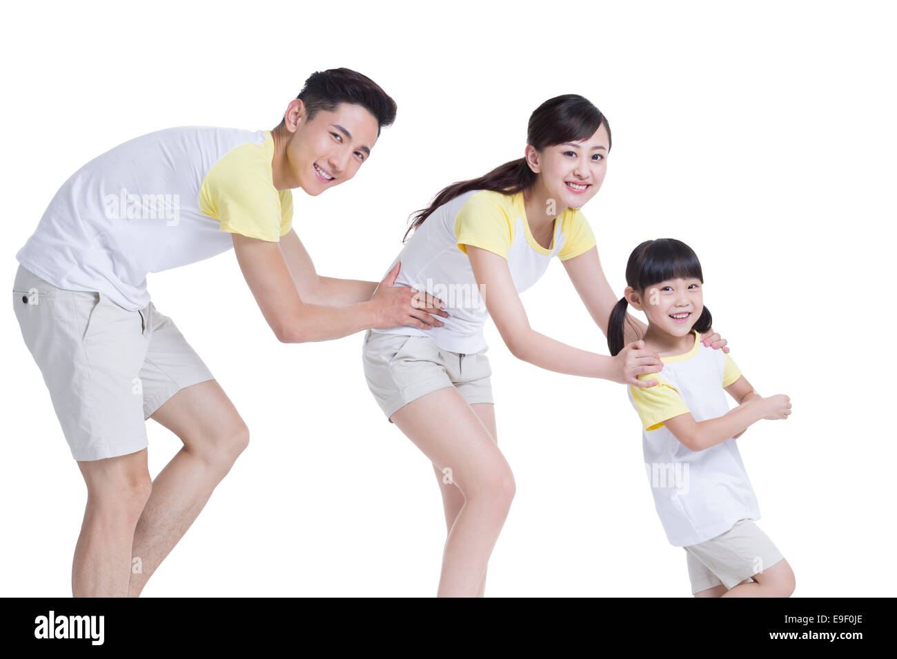 Happy young family walking in train formation Stock Photo - Alamy