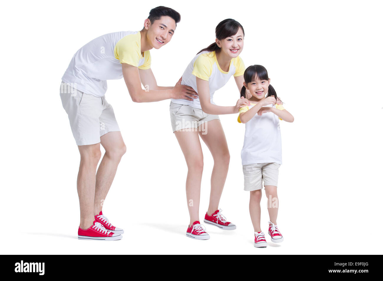 Happy young family walking in train formation Stock Photo - Alamy
