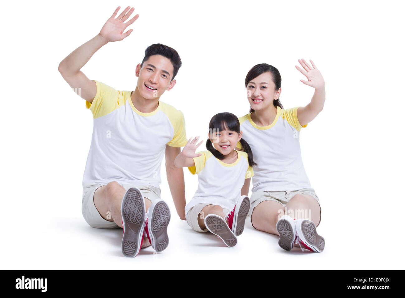 Happy young family waving Stock Photo - Alamy
