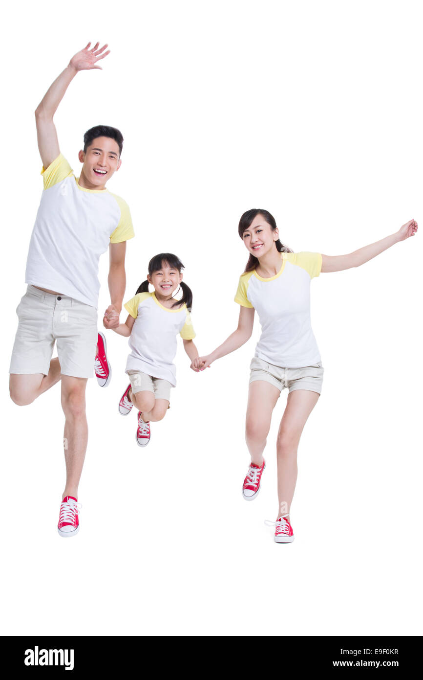 Happy young family jumping Stock Photo - Alamy