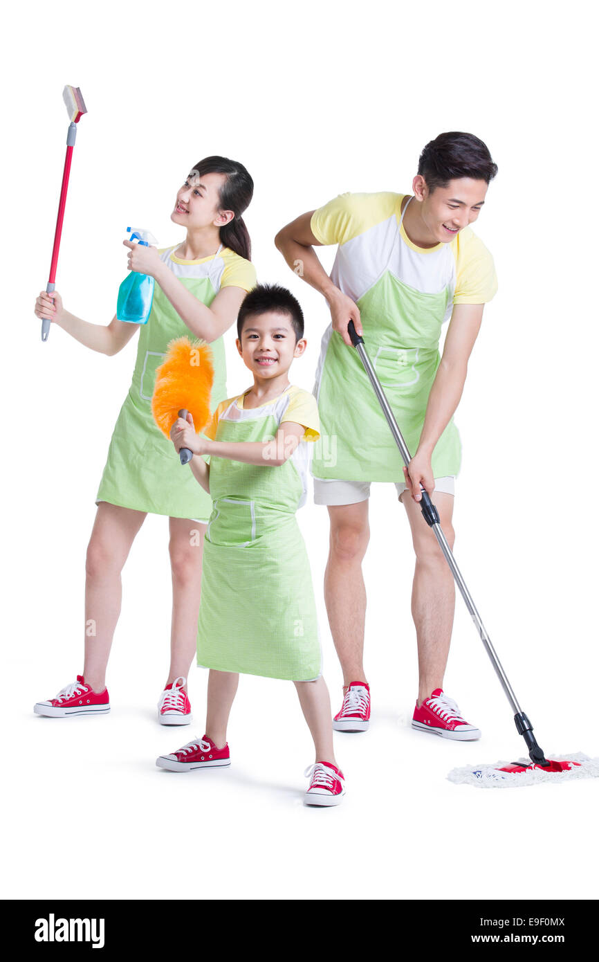 Happy young family with cleaning supplies Stock Photo - Alamy
