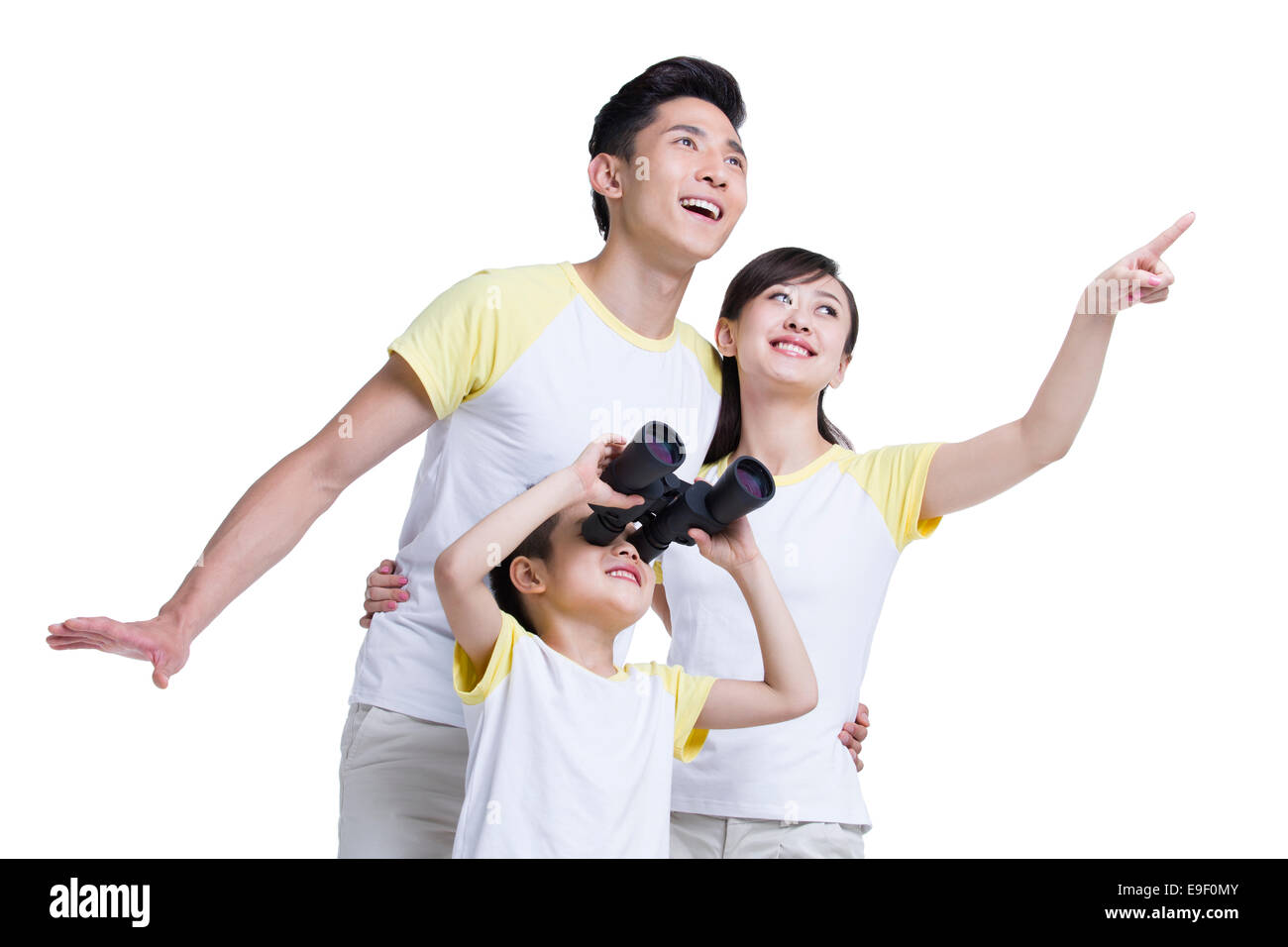 Happy young family looking at view with a telescope Stock Photo - Alamy