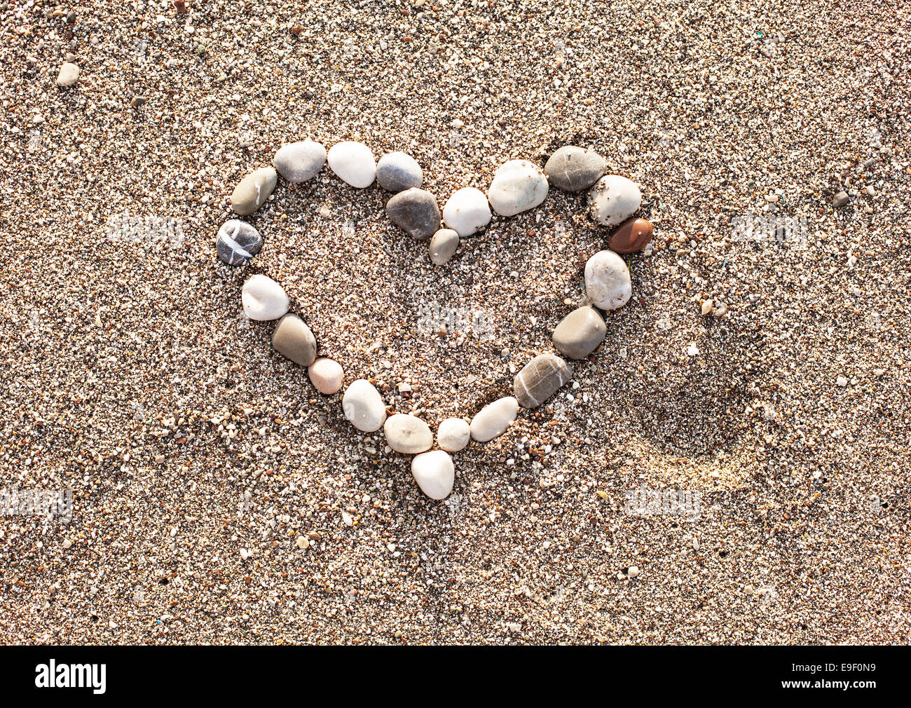 Heart of marine shingles on the sand Stock Photo - Alamy