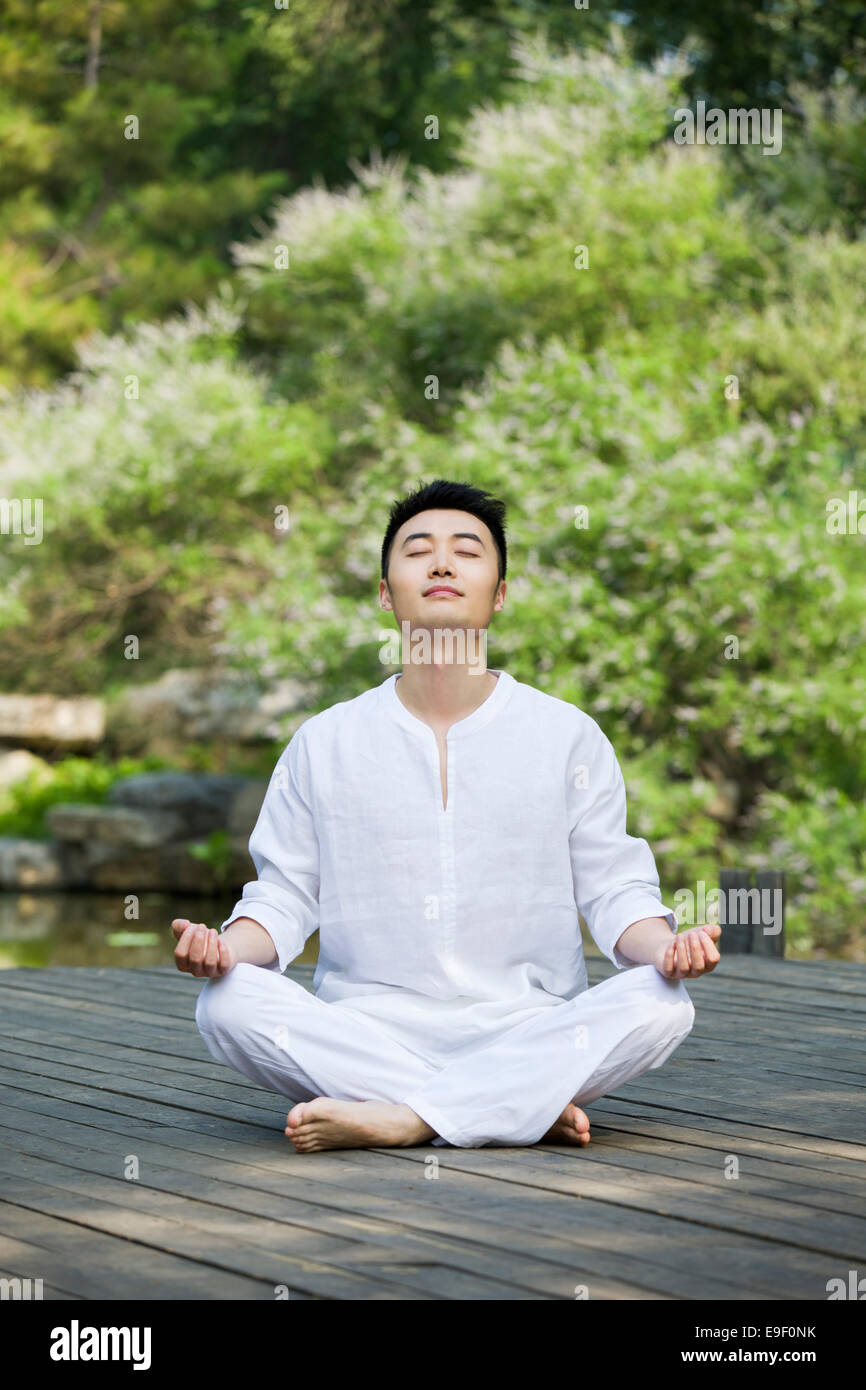 Young man in meditation Stock Photo - Alamy