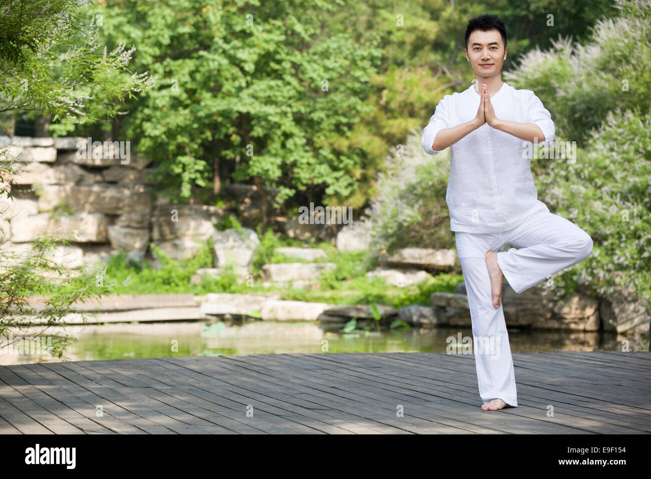 Young man practicing yoga Stock Photo - Alamy