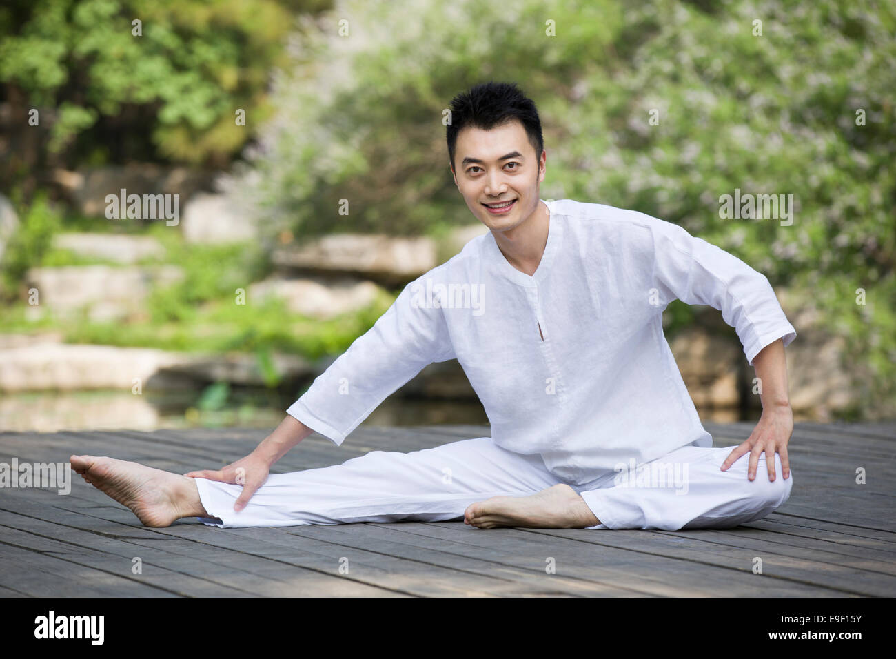 Young man practicing yoga Stock Photo - Alamy