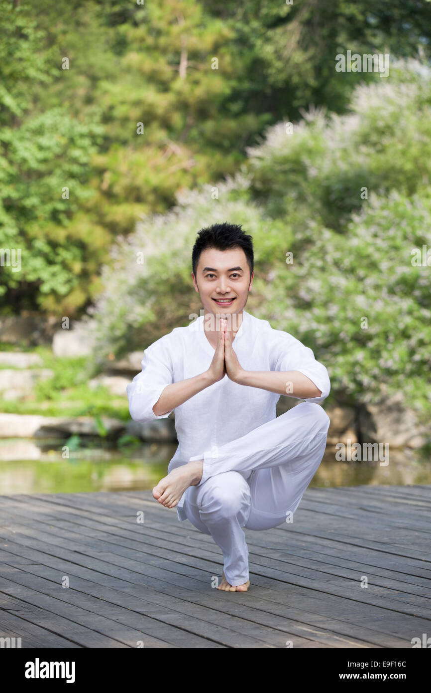 Young man practicing yoga Stock Photo - Alamy