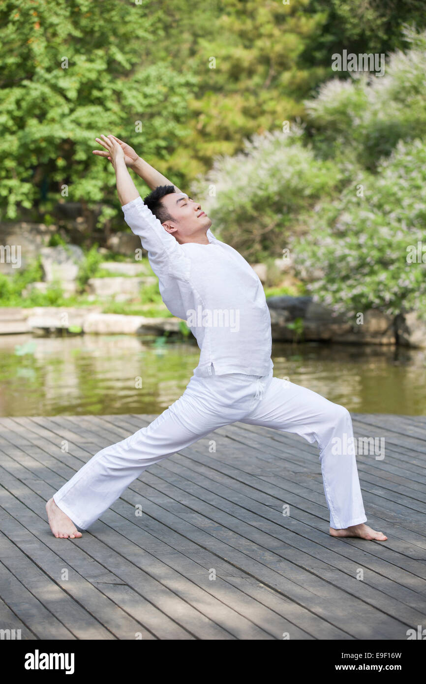 Young man practicing yoga Stock Photo - Alamy