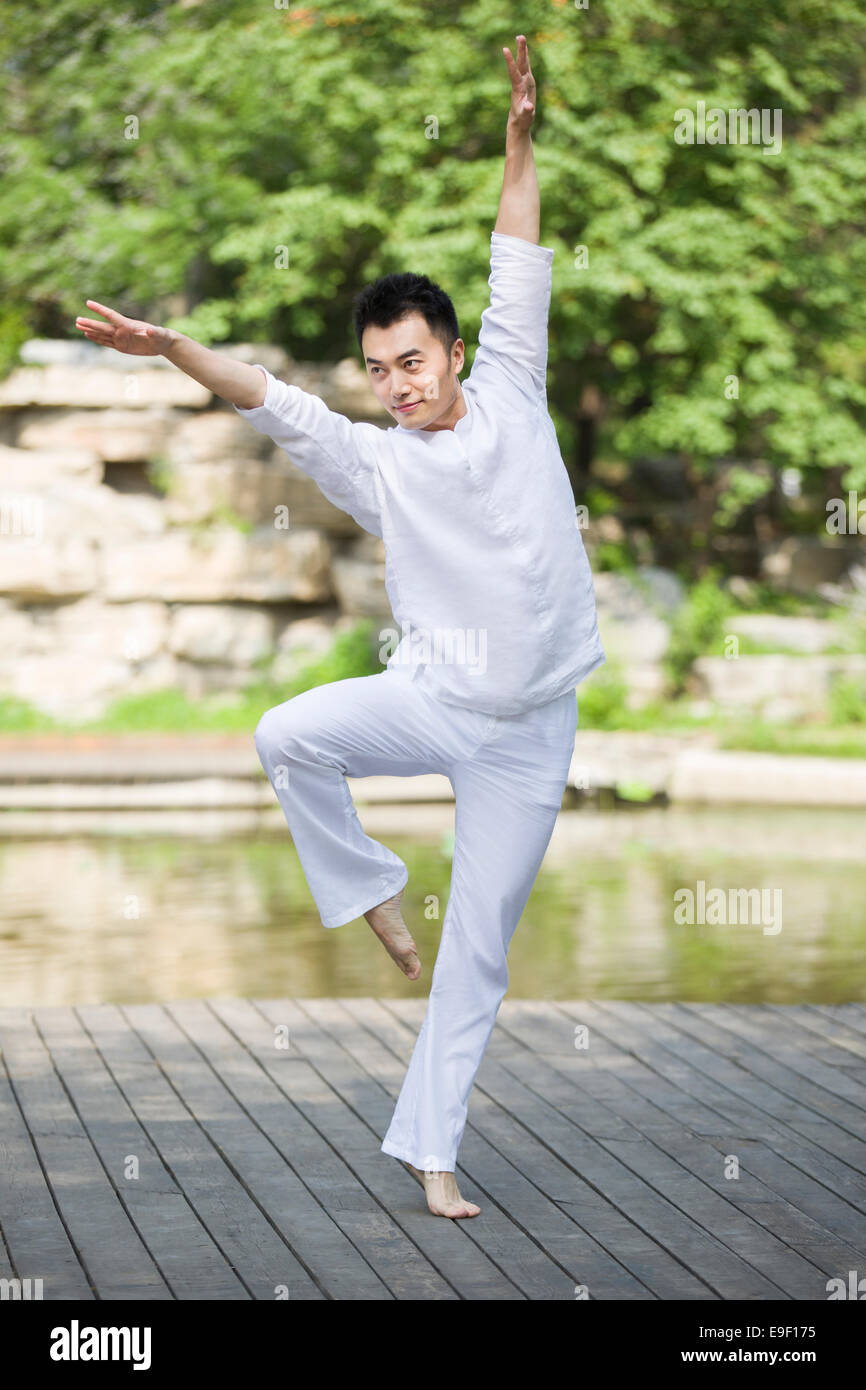Young man practicing yoga Stock Photo - Alamy